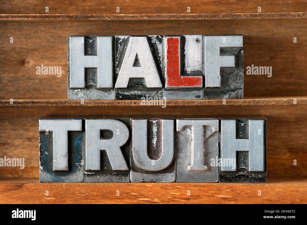 half truth phrase made from metallic letterpress type on wooden tray ...