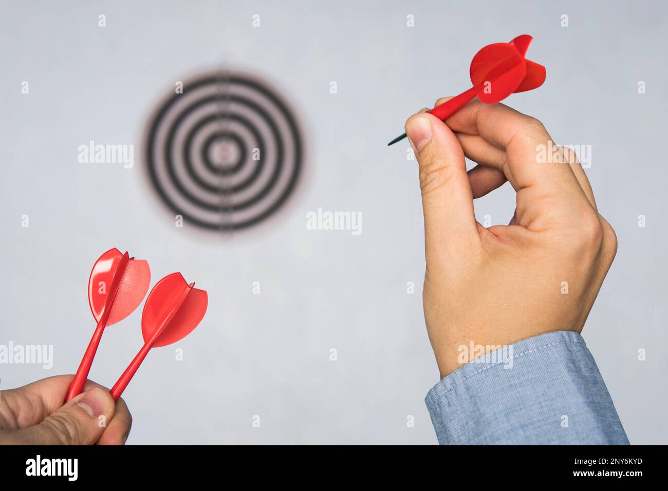 Businessman holding a dart aiming at the target - business targeting ...