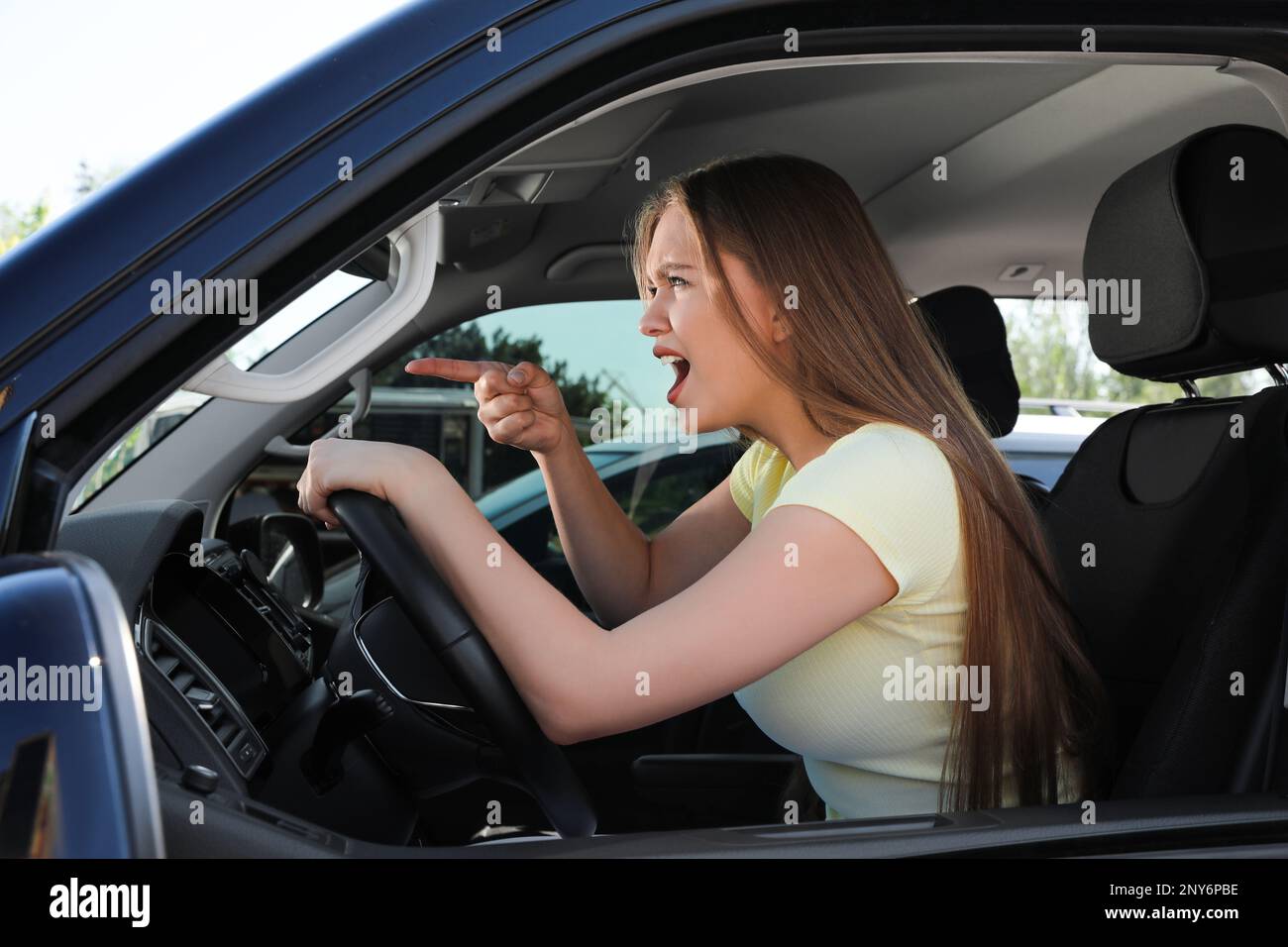 Emotional woman in car. Aggressive driving behavior Stock Photo - Alamy