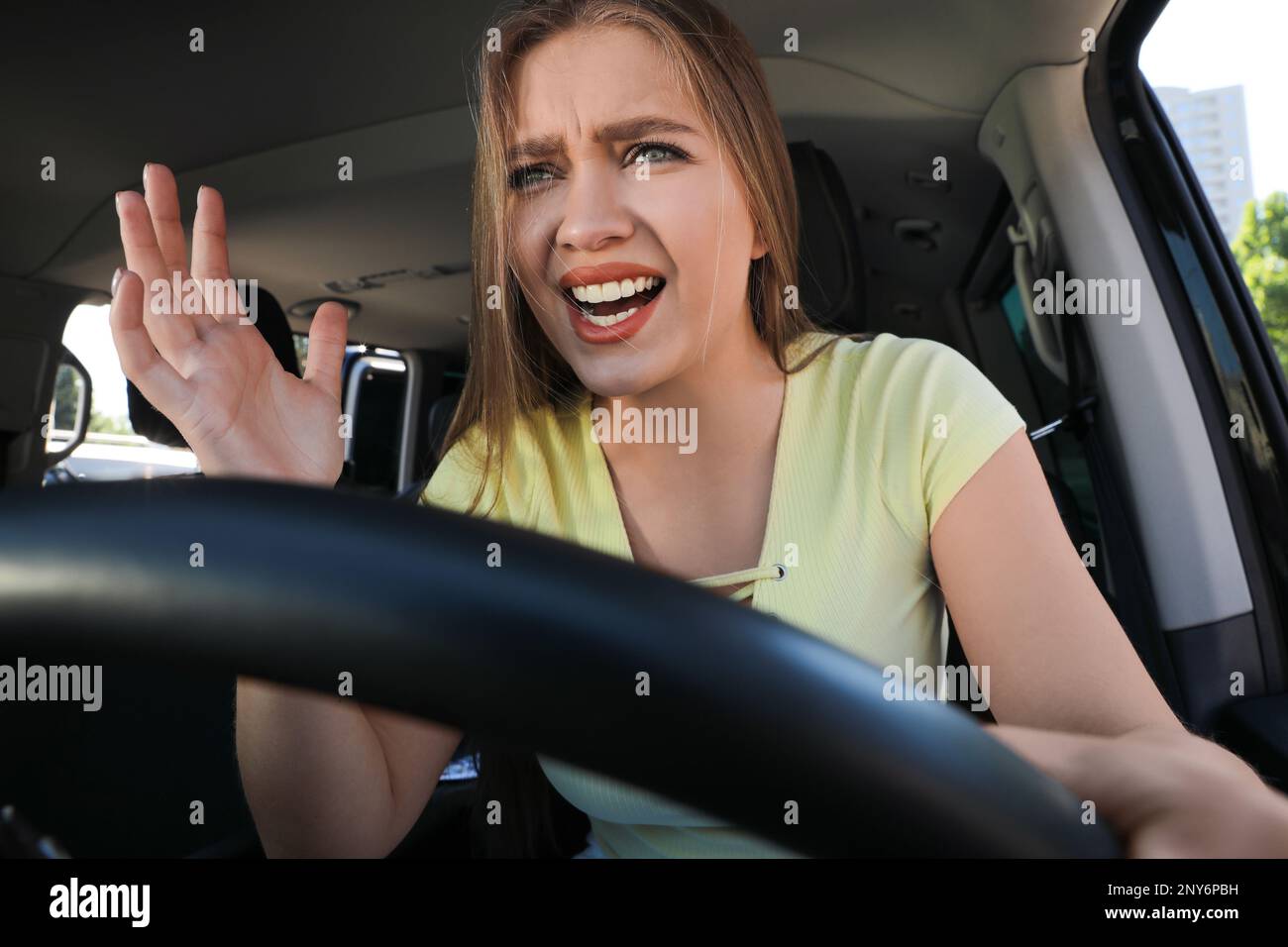 Emotional woman in car. Aggressive driving behavior Stock Photo - Alamy