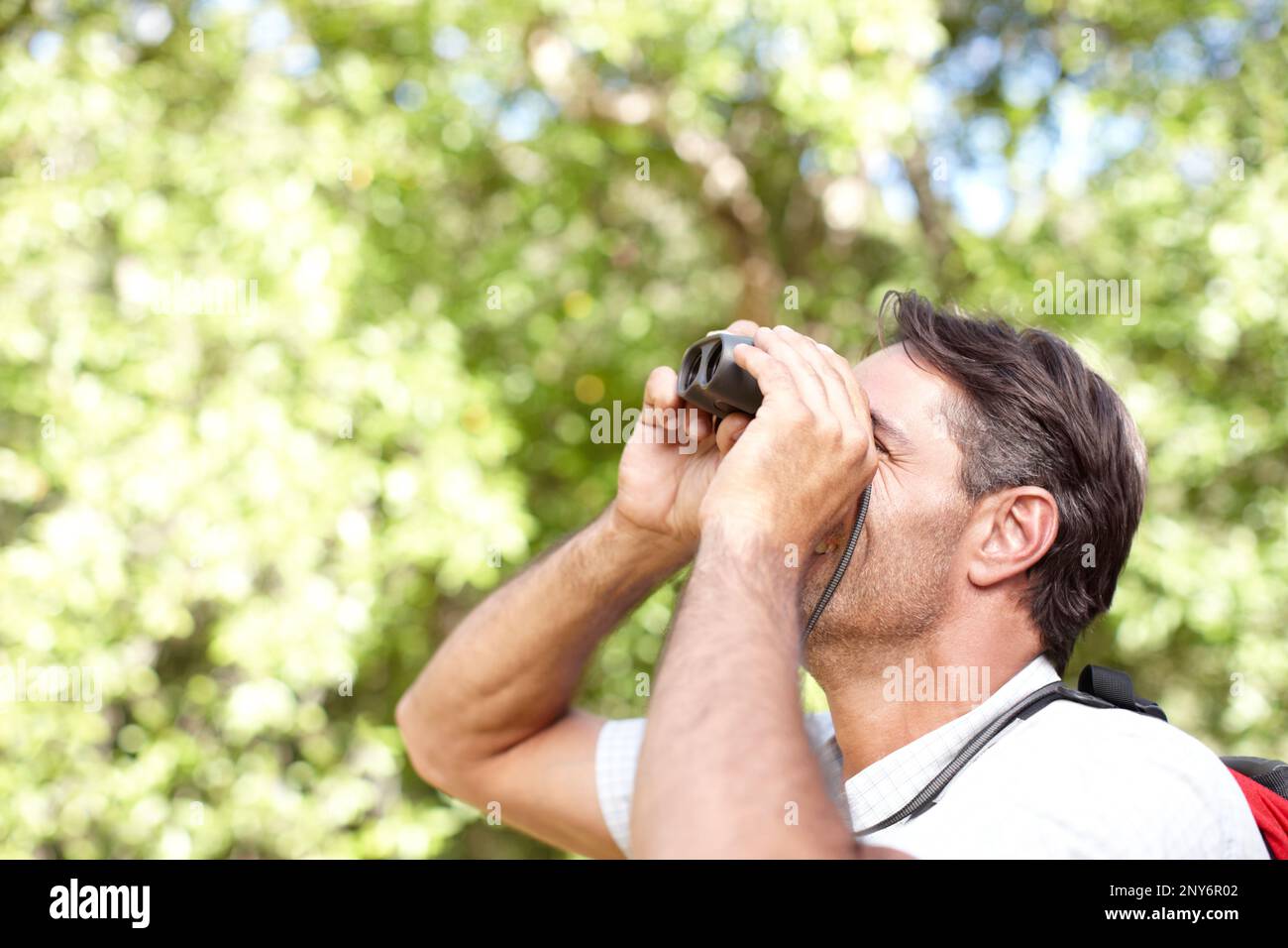You can see so much from here. A young man looking at something through ...
