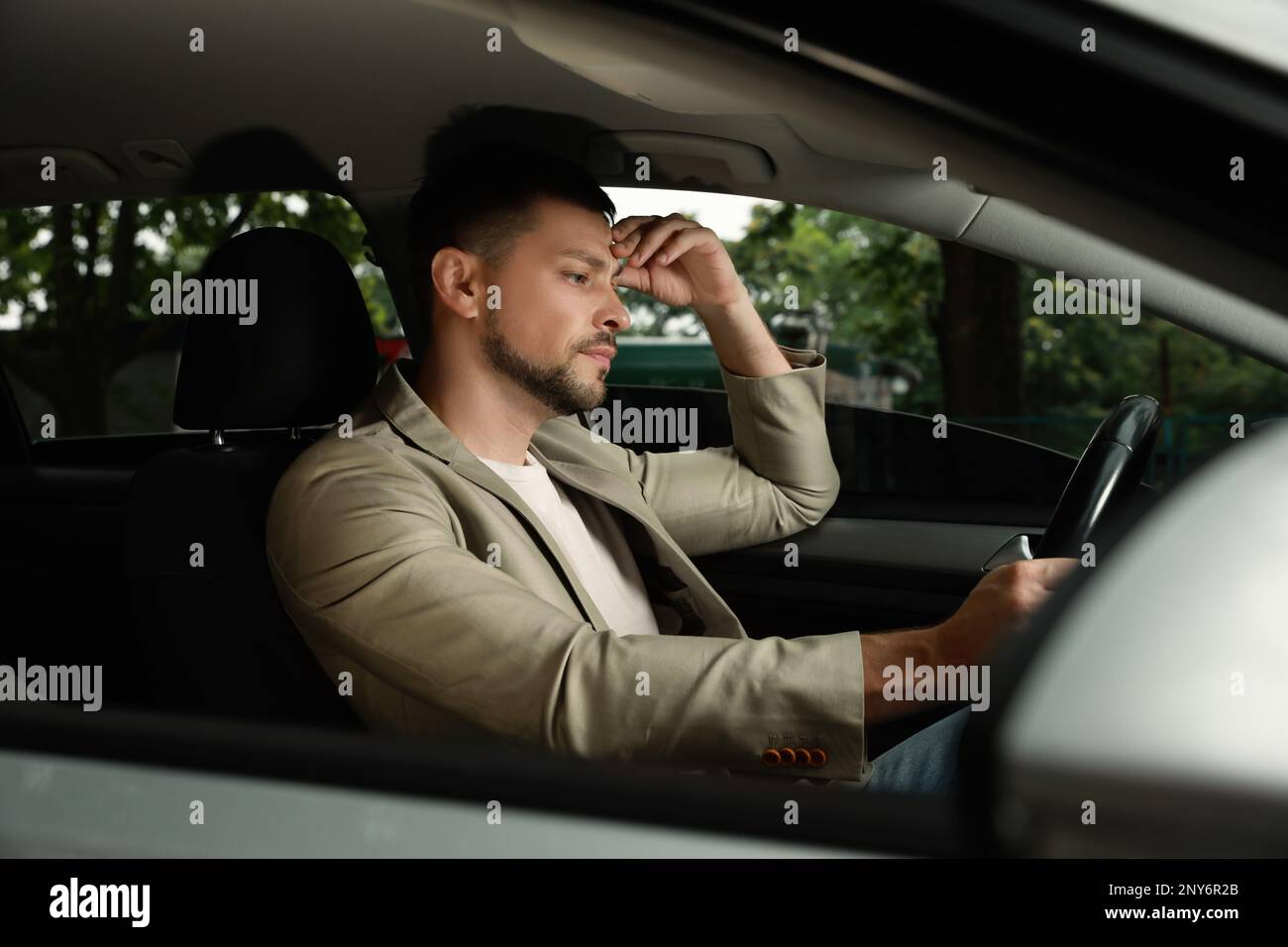 Stressed businessman in driver's seat of modern car Stock Photo - Alamy