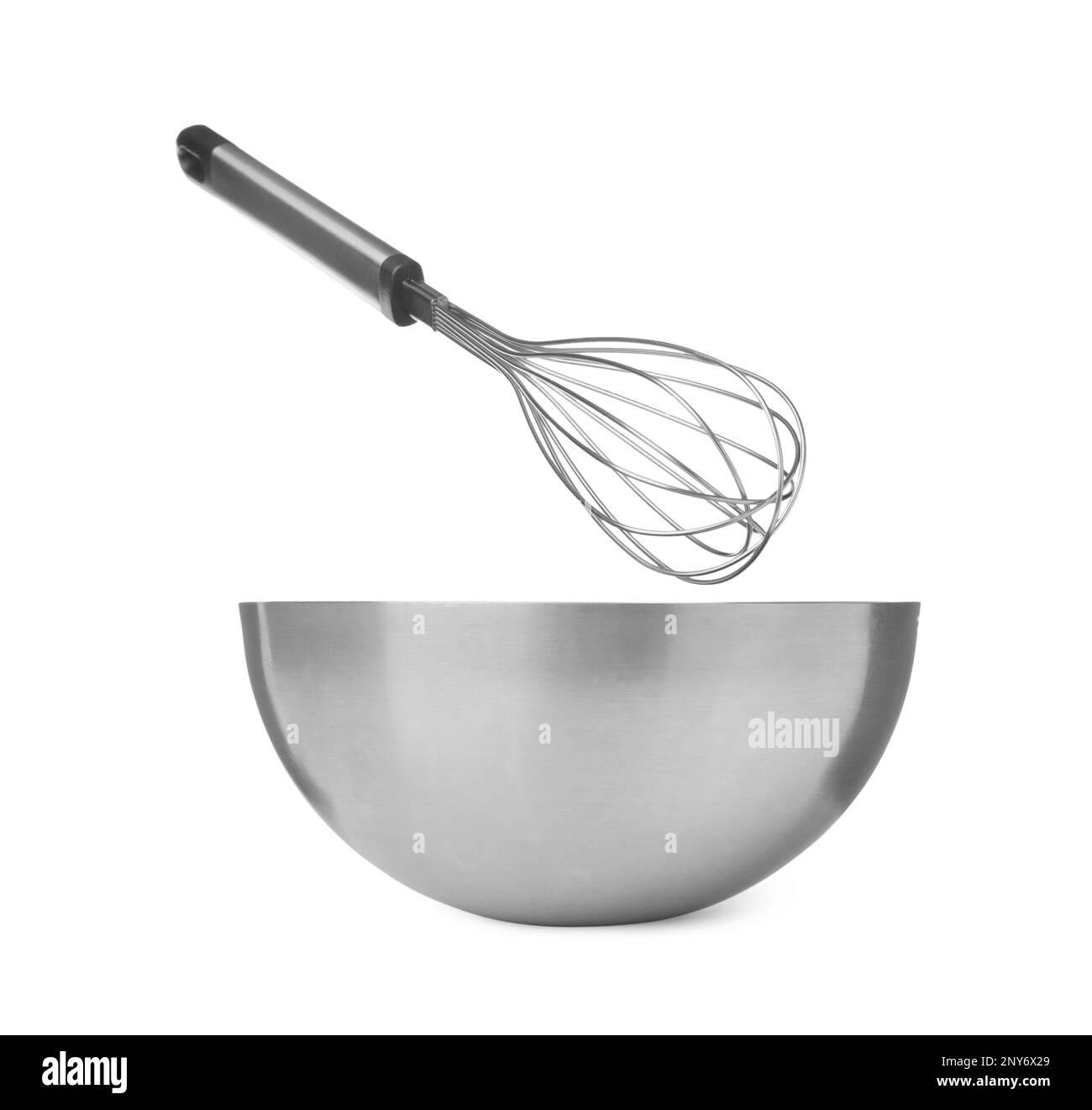 Metal balloon whisk and bowl on white background Stock Photo - Alamy