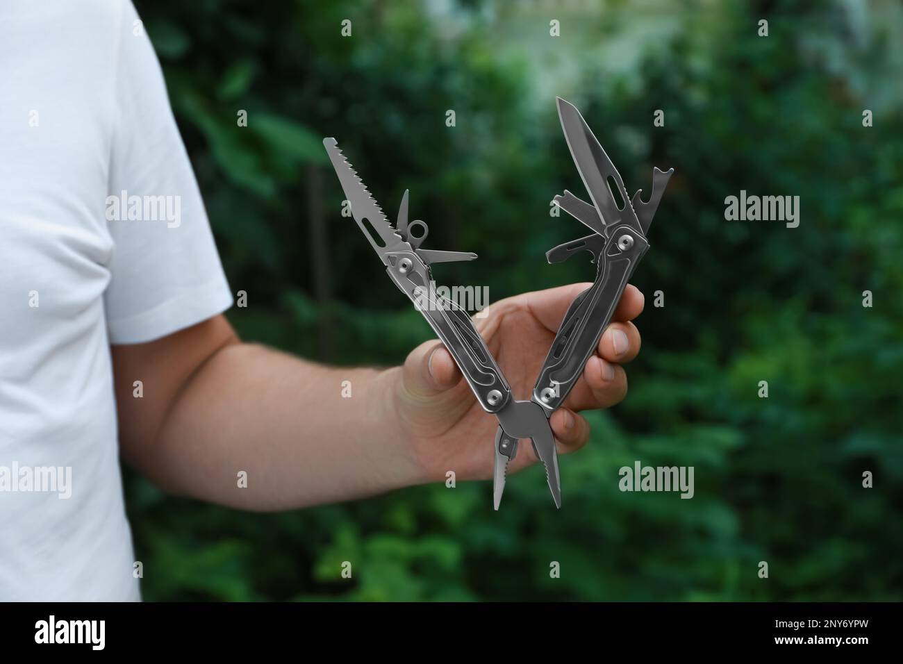 Man holding compact portable multitool outdoors, closeup Stock Photo ...