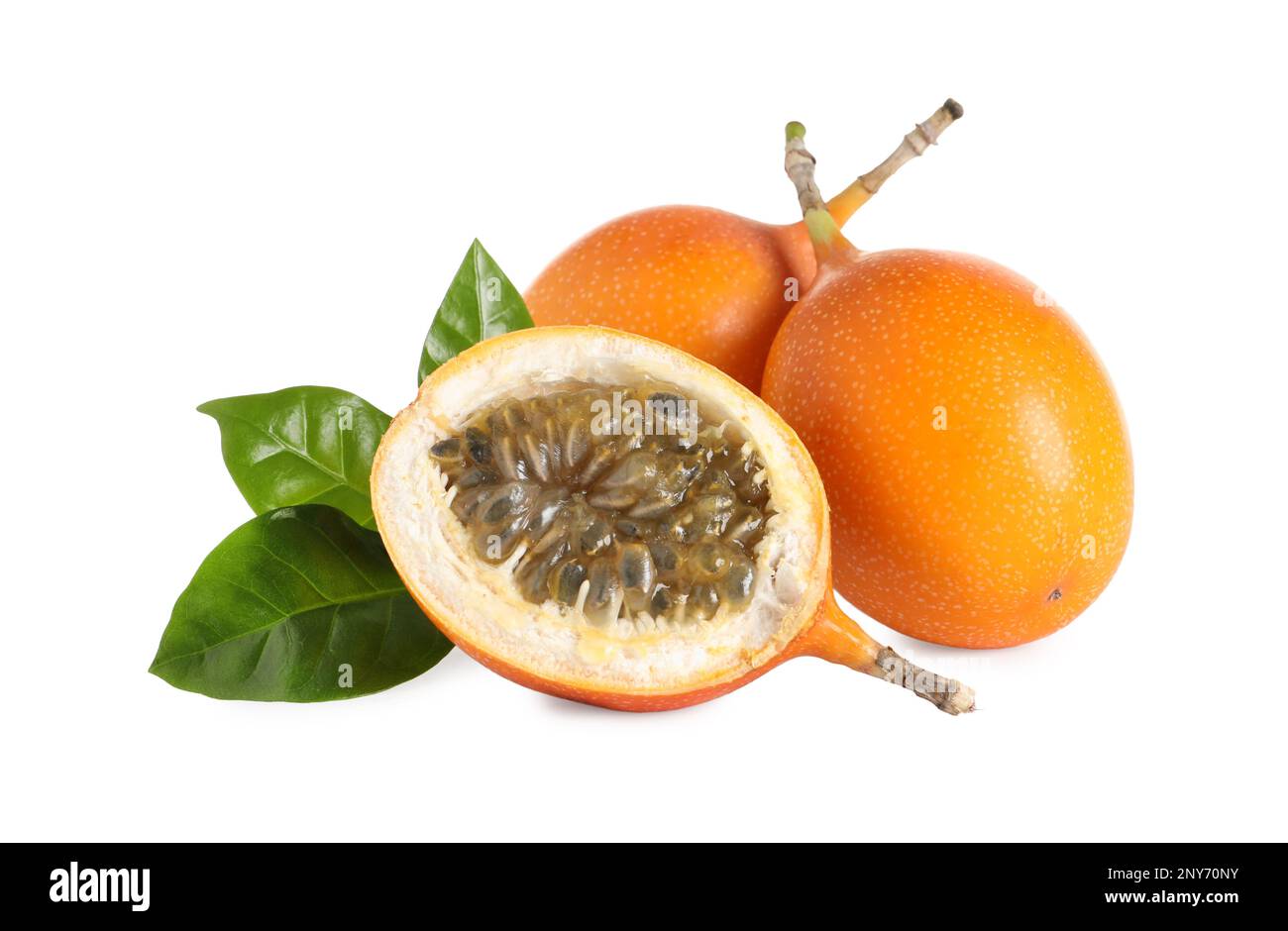 Whole and cut delicious ripe granadillas with green leaves on white ...