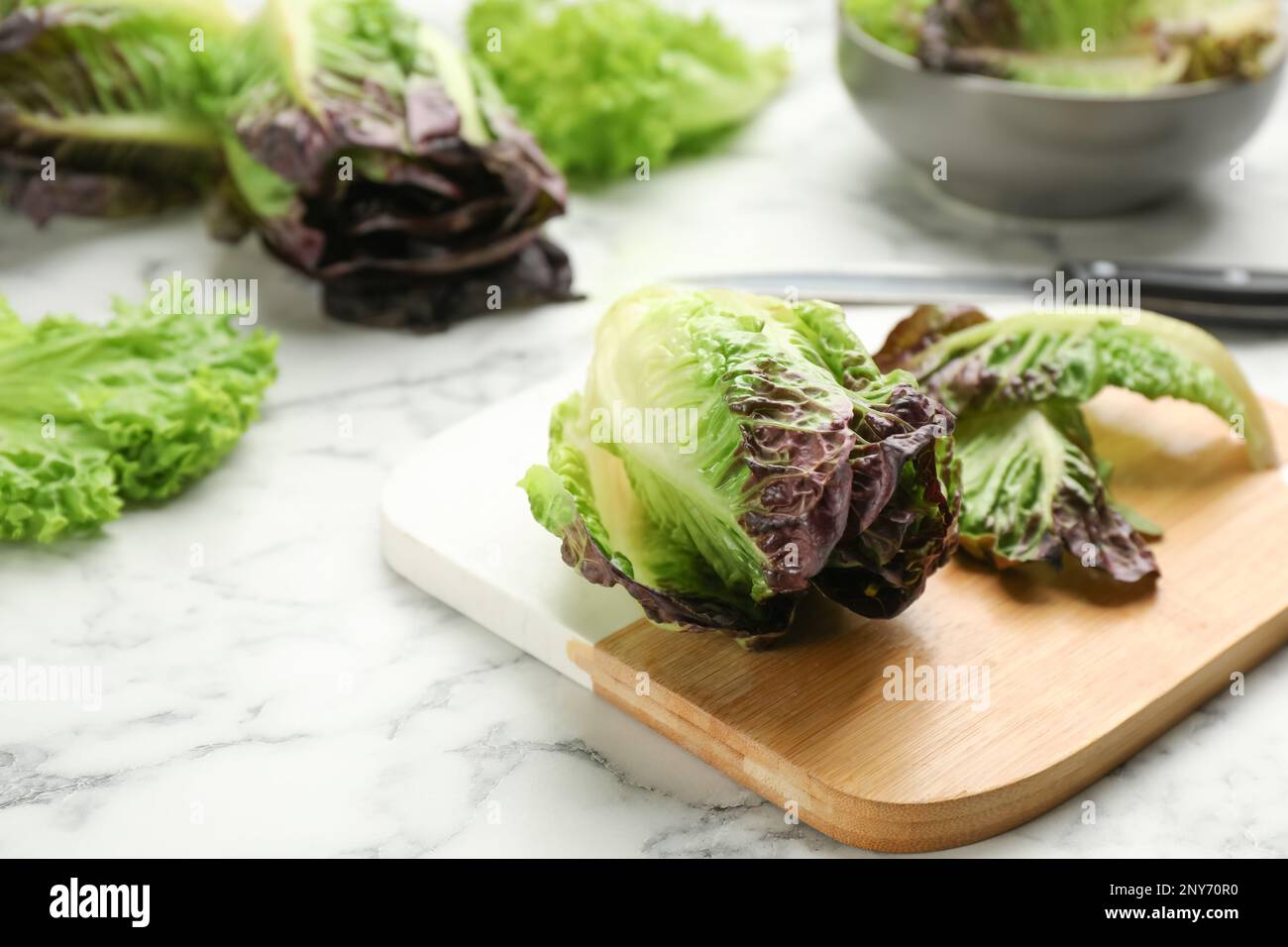 Red romaine lettuce on white marble table, space for text Stock Photo ...