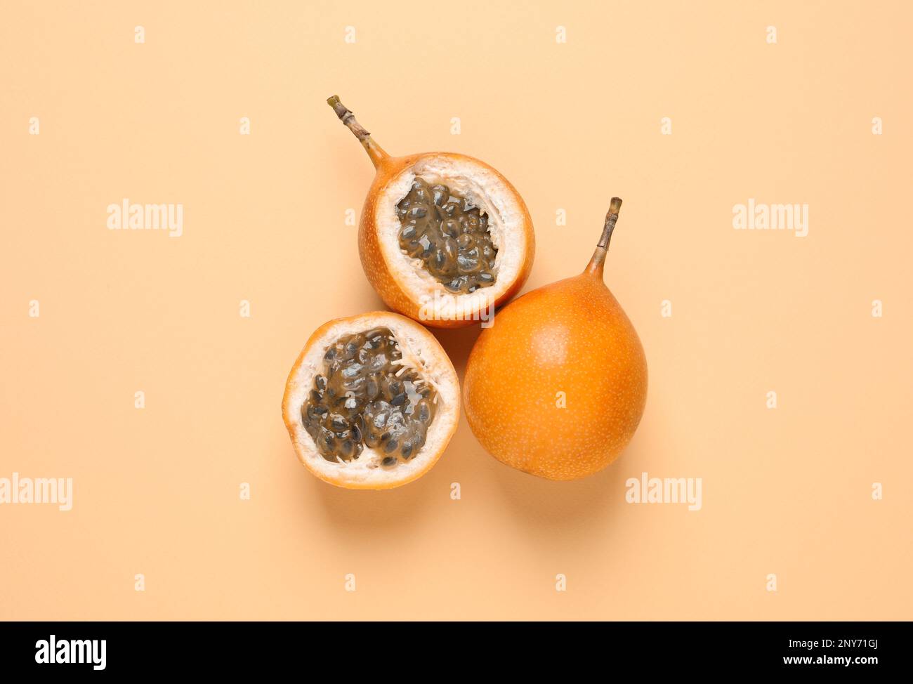 Delicious ripe granadillas on beige background, flat lay Stock Photo ...