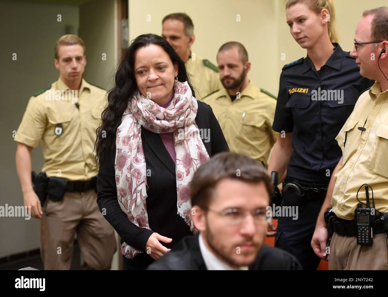 Defendant Beate Zschaepe, center, arrives at the court room in Munich ...
