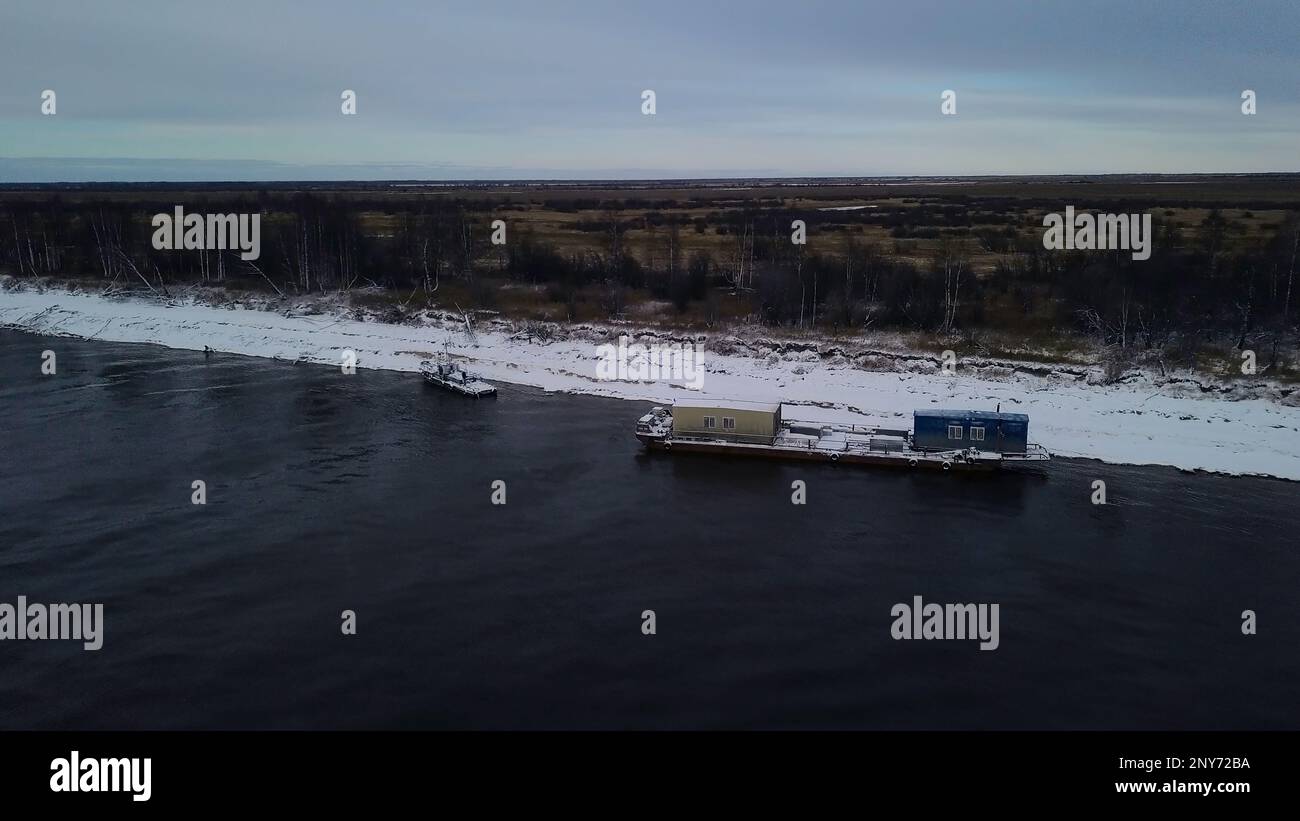 Aerial view of a barge on a winter river with ice. Clip. Concept of ...