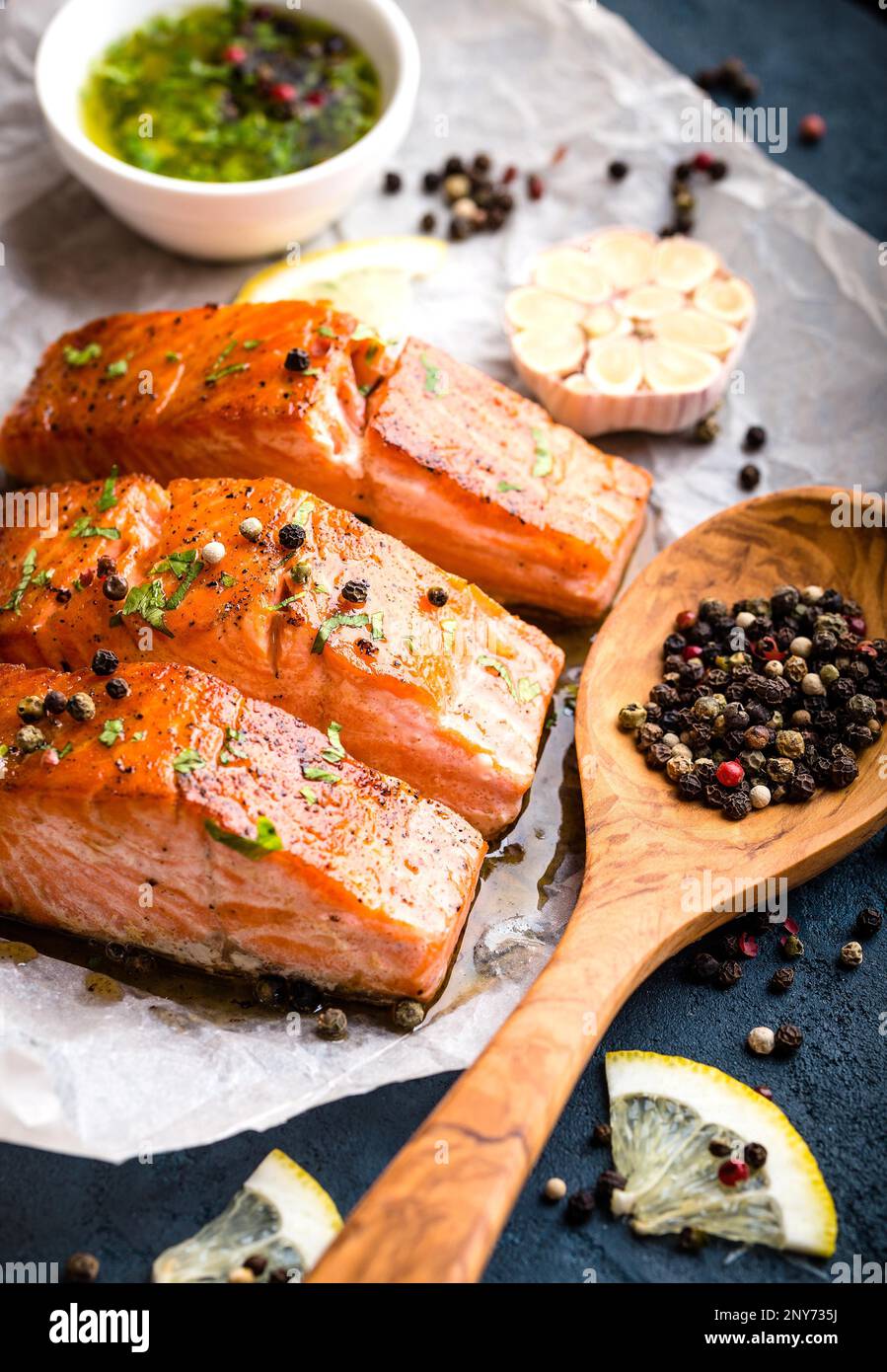 Delicious fried salmon fillet, seasonings on blue rustic concrete table ...