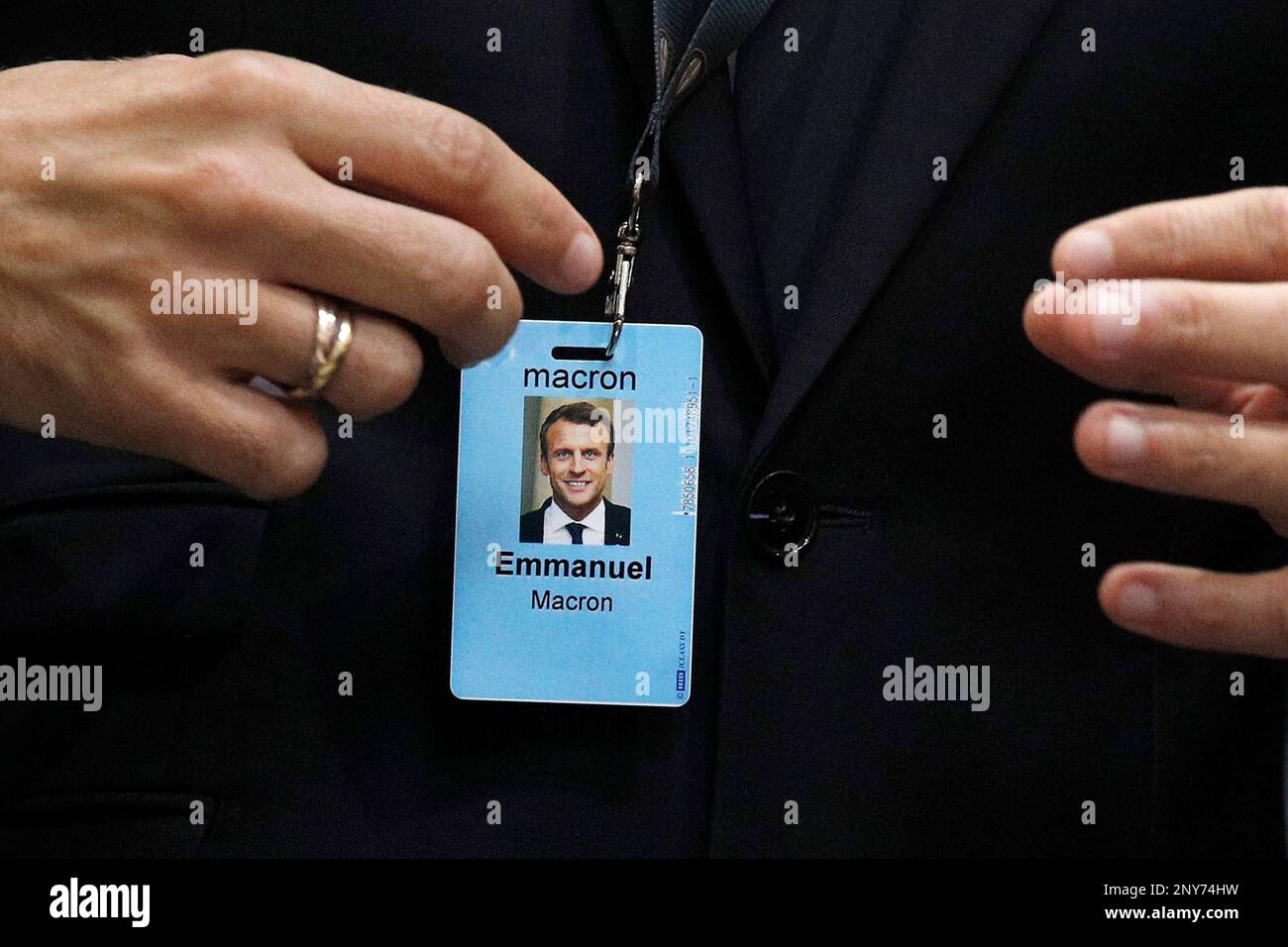 French President Emmanuel Macron wears a badge during a visit at the ...