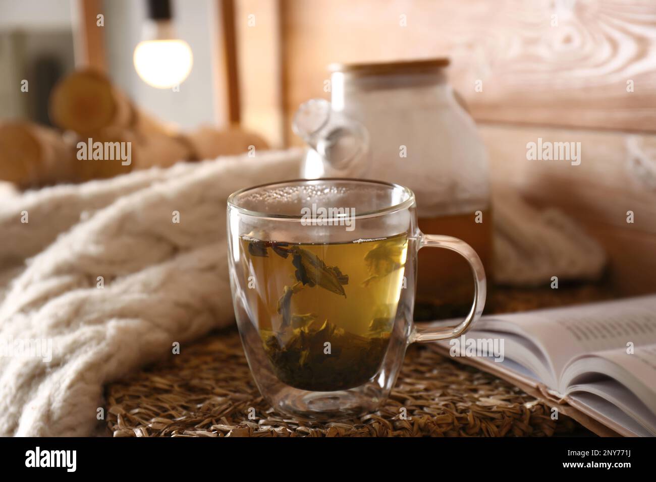 Freshly brewed tea and open book on table. Cozy home atmosphere Stock ...