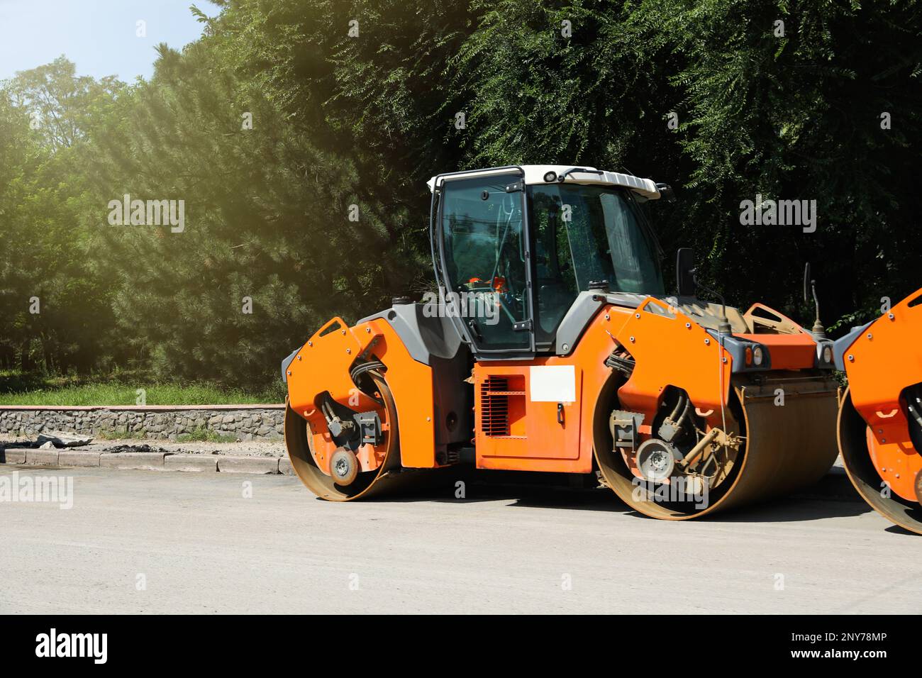 Modern roller on city street. Road repair service Stock Photo - Alamy