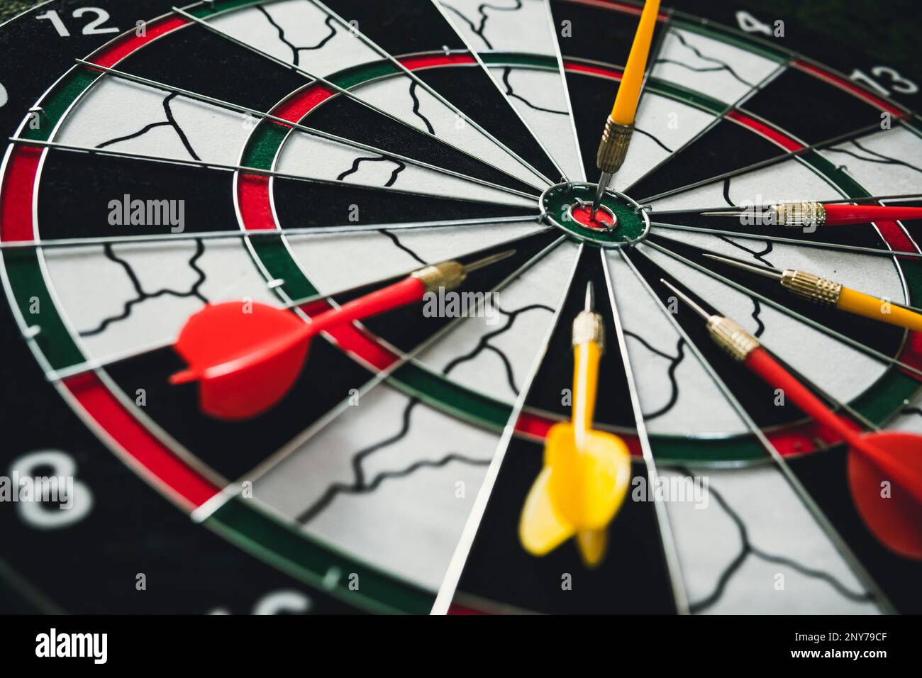 Close yellow dart on target board right frame. yellow and red Darts lie ...