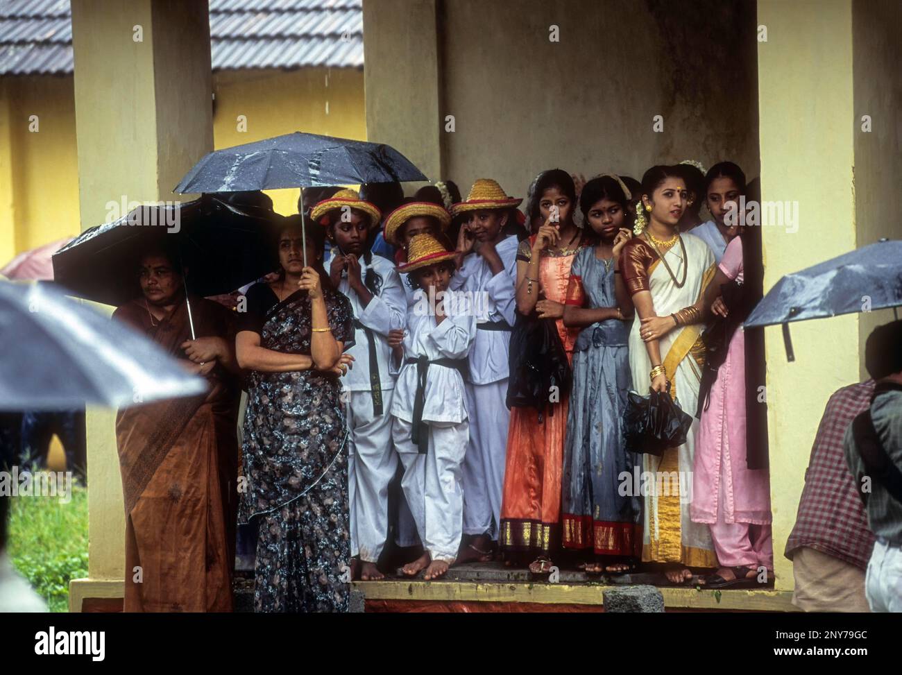 School children Waiting during rainingm, monsoon in Tripunithura near ...