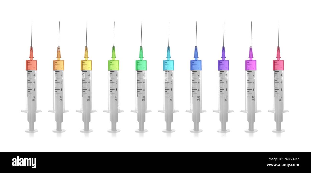 Disposable syringes with needle and multicolored medicine on white ...