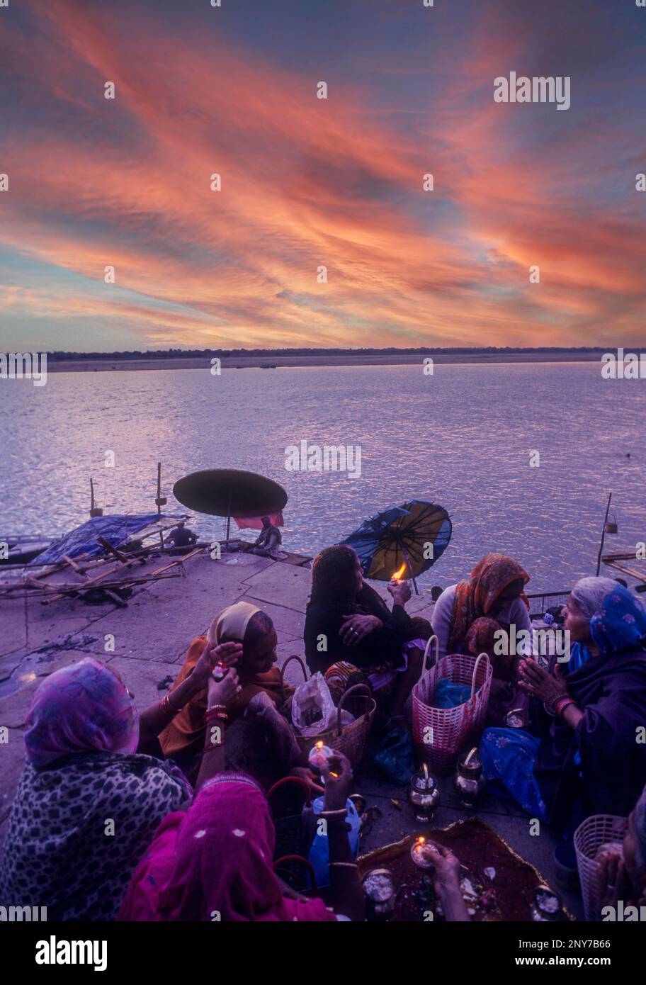 Women offering ritual prayers on the steps of the Ganga Ganges ghat at ...