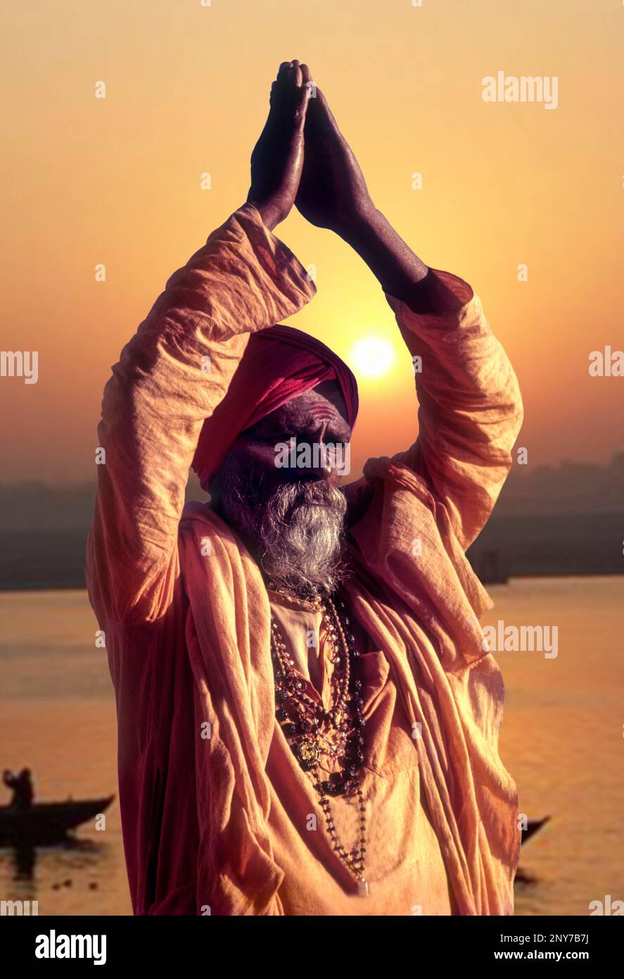 A sadhu worshipping river Ganga Ganges at Varanasi, Uttar Pradesh ...