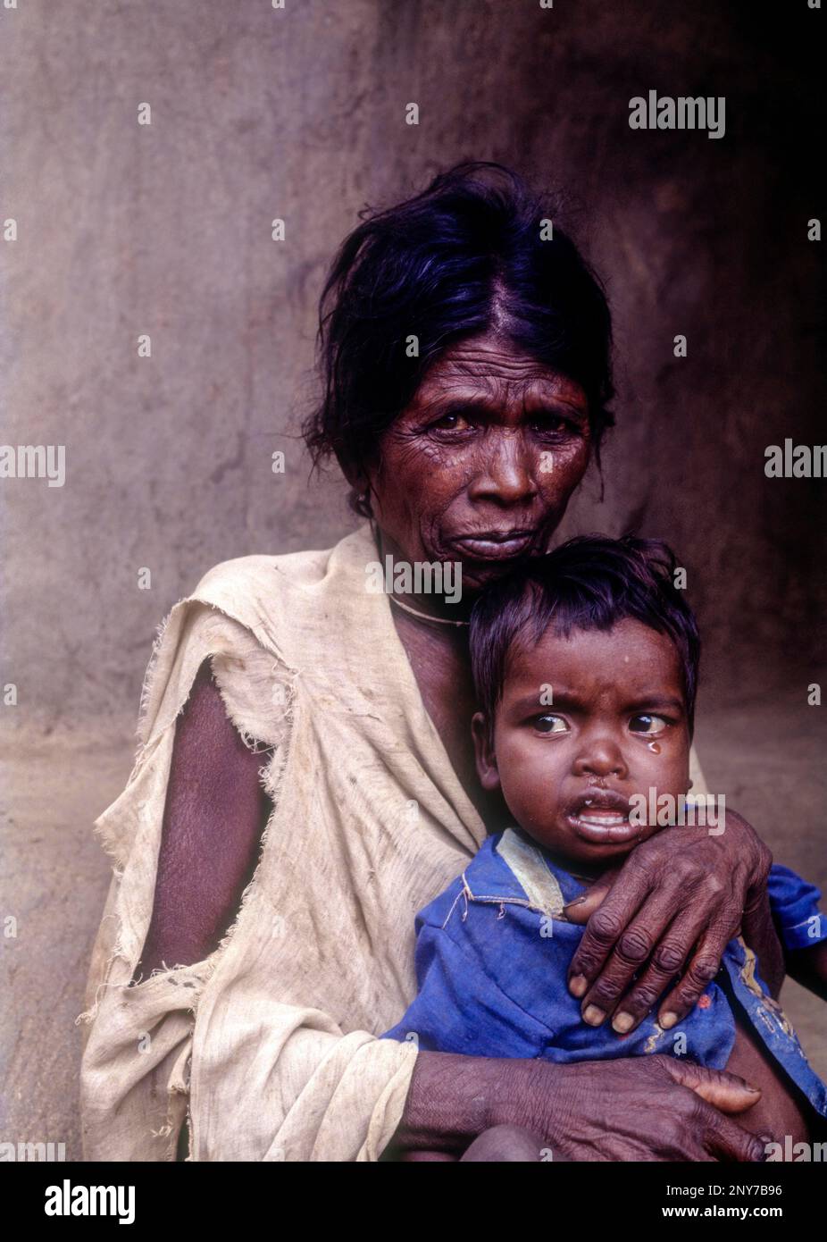 Jenu Kurumba tribal with son at Nagarhole, Karnataka, South India ...