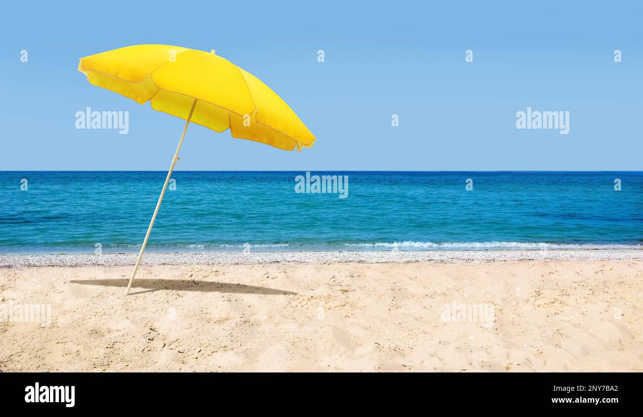 Open big beach umbrella on sandy coast Stock Photo - Alamy