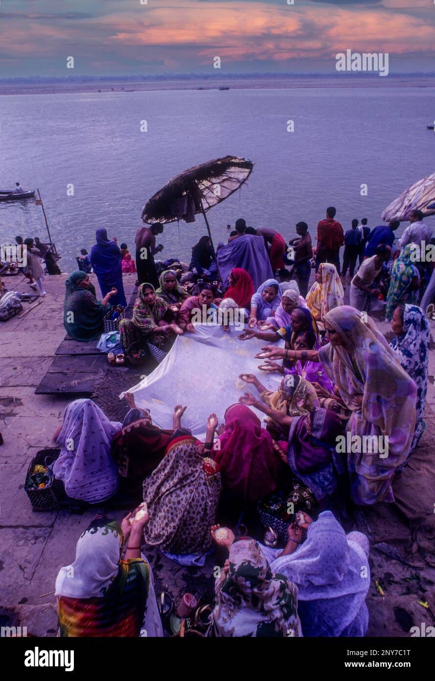 Women with lighted diyas praying to basel plant Tulsi puja on Ganga ...