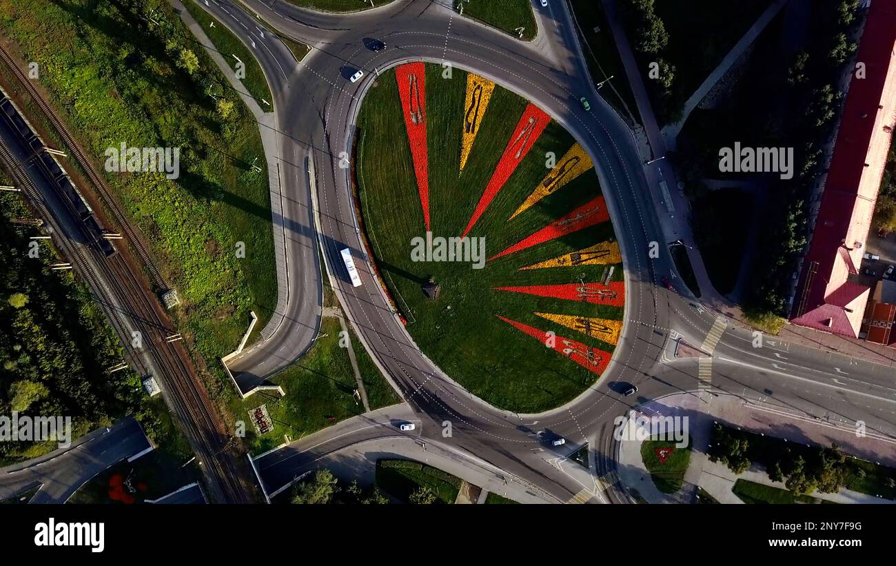 Aerial view of a round shaped crossroad with moving cars. Clip. Green ...