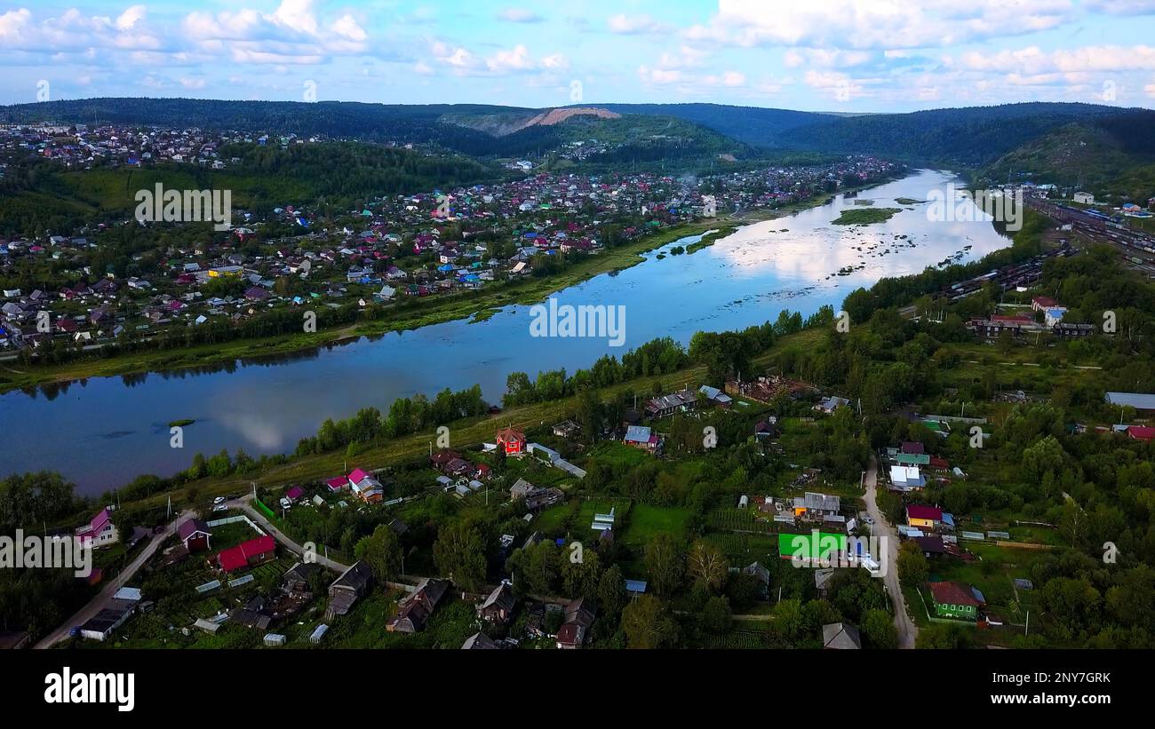 Arial view of a small town crossed by a river with a bridge. Clip ...