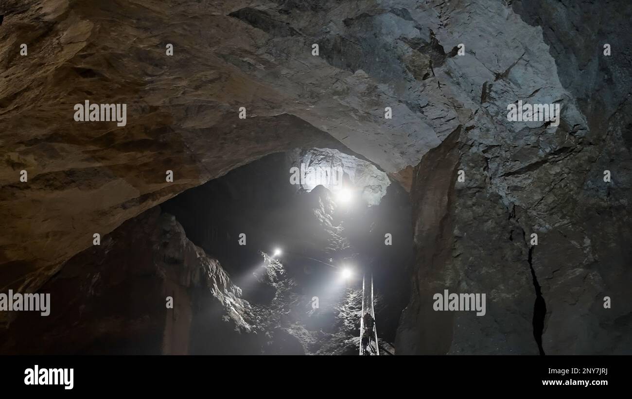 Speleology artificial cave with sunlight shining through holes. Action ...