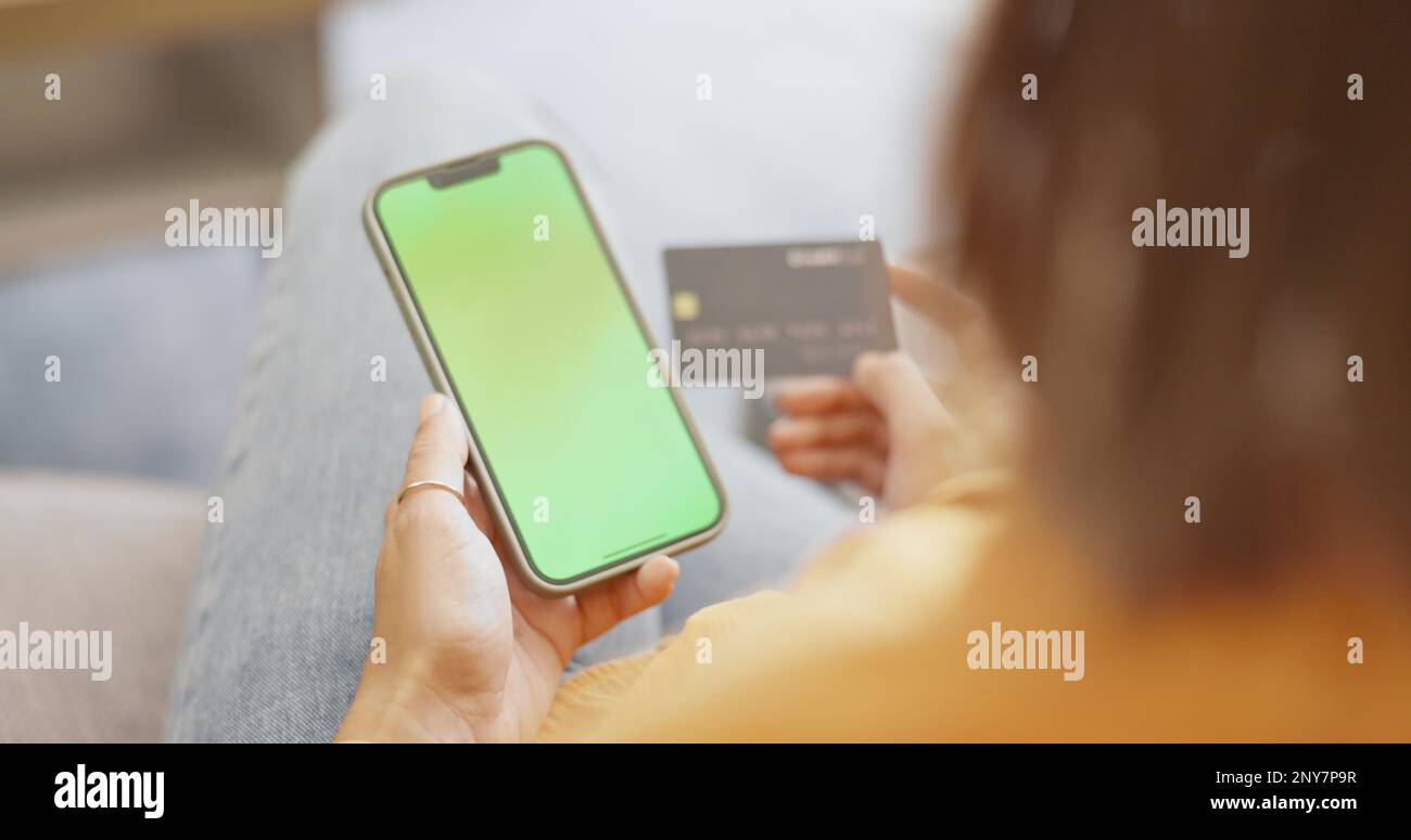 Top view, smartphone and woman with credit card, green screen and ...