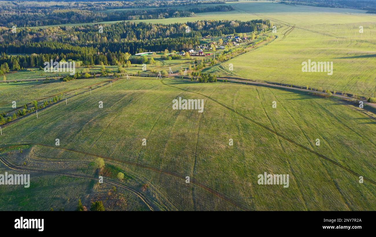 Aerial view of a rural countryside road stretching along farm fields ...
