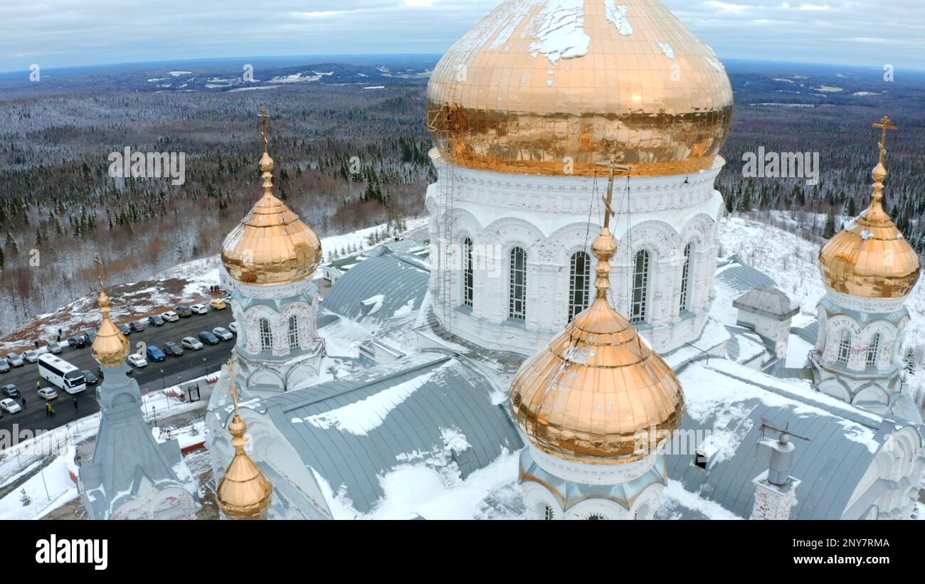 Aerial view of a white church with golden domes on a winter day. Clip ...