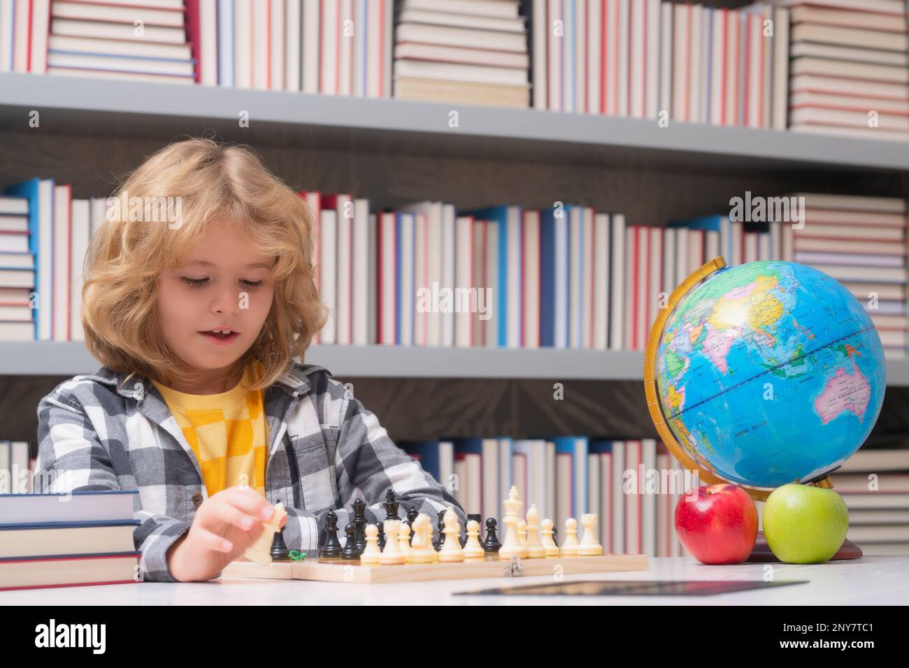 Child play chess in classroom. Kid playing chess. Child thinking near ...