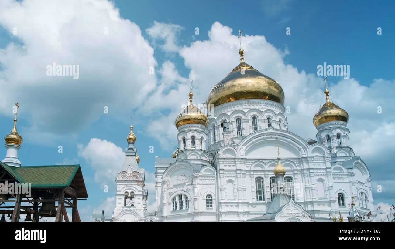 Aerial view of A white church with golden domes. Clip. Large beautiful ...