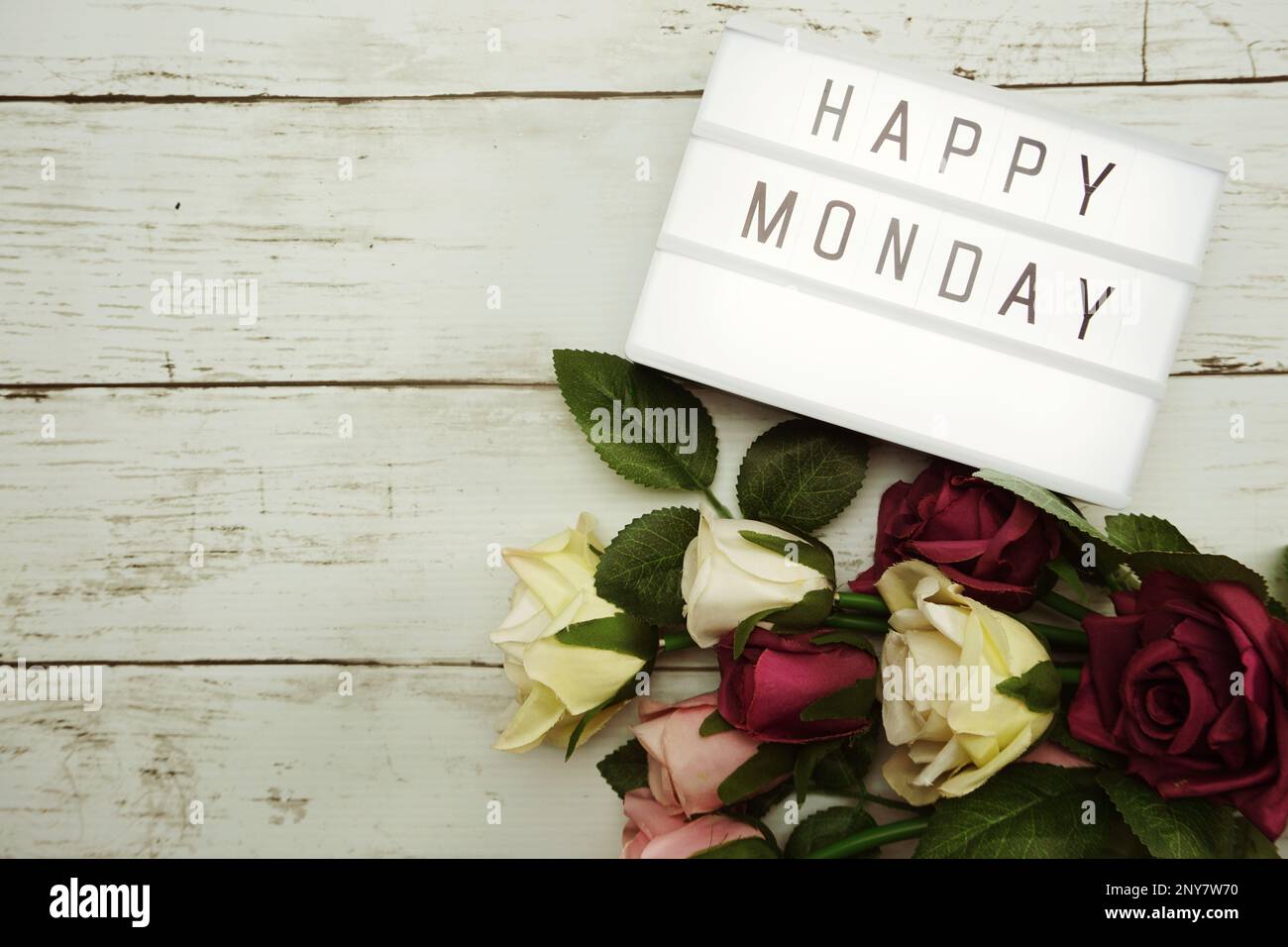 Happy Monday Word on Light box with roses flower bouquet on wooden ...