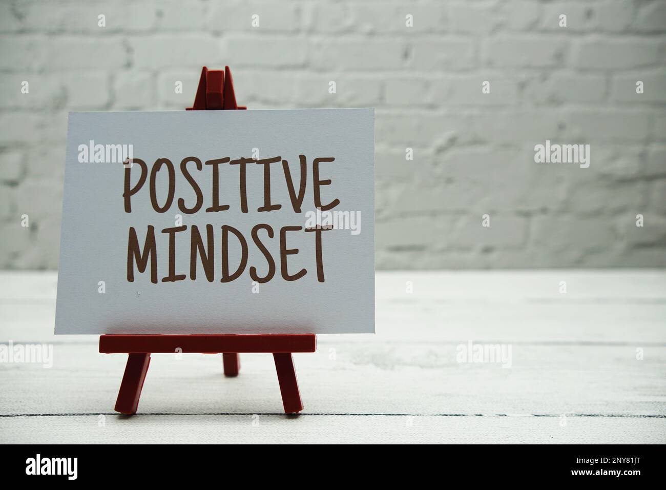 Positive Mindset text on white brick wall and wooden background Stock ...