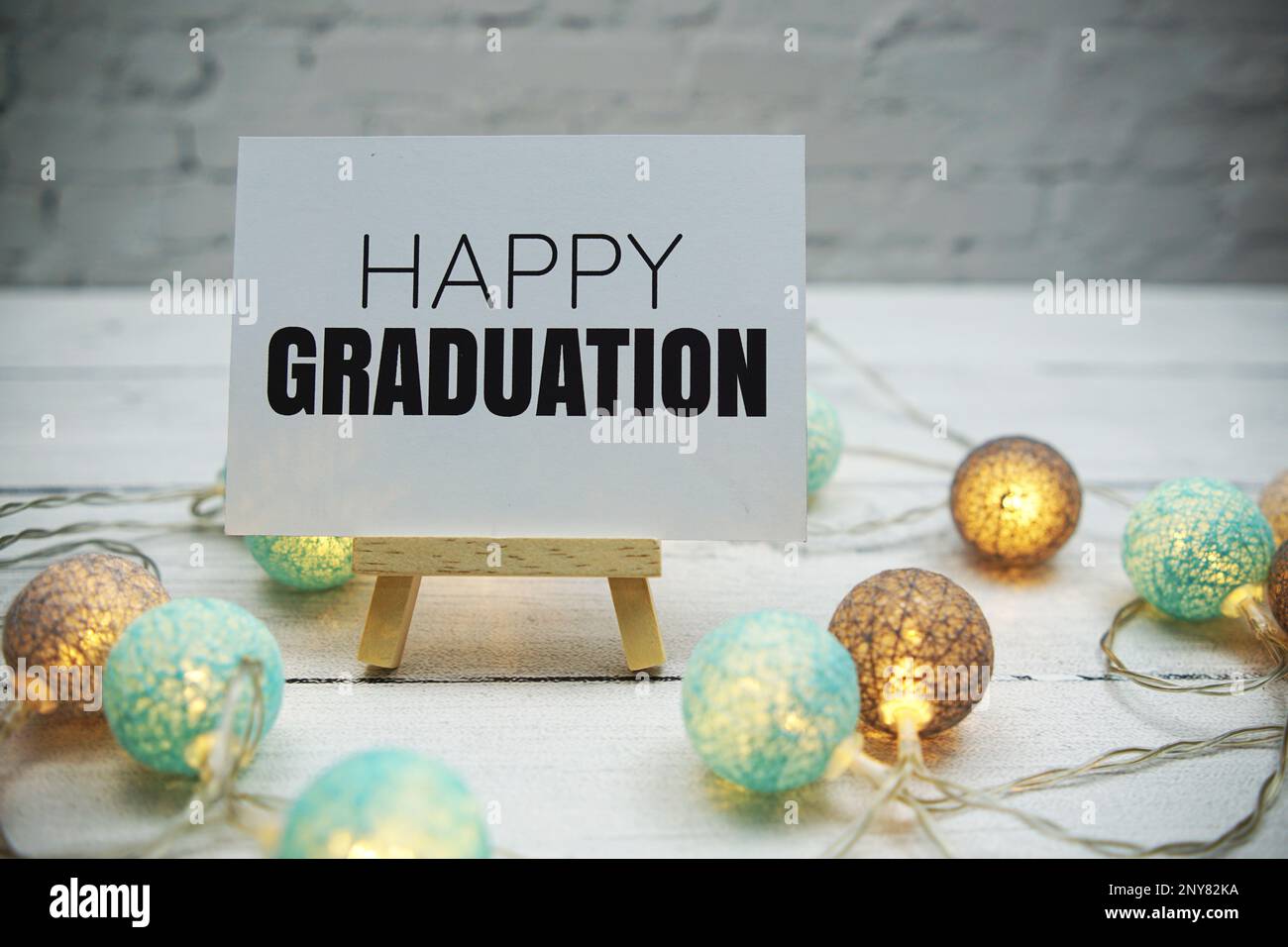 Happy Graduation text on white brick wall and wooden background Stock ...