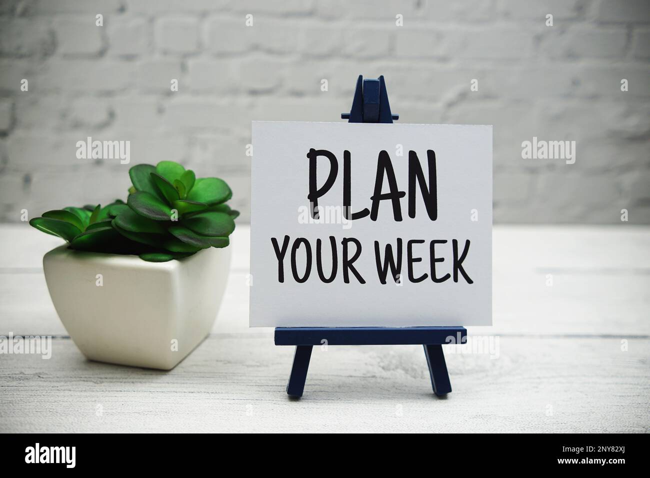 Plan Your Week text on white brick wall and wooden background Stock ...