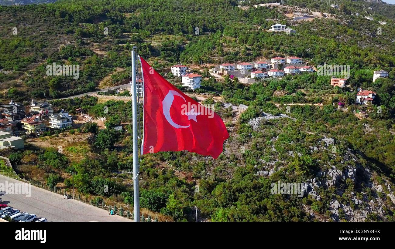 Aerial view of a Turkey national red flag. Clip. Summer green mountain ...