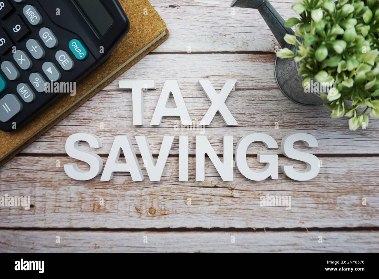 Tax Savings alphabet letters with calculator on wooden background Stock ...