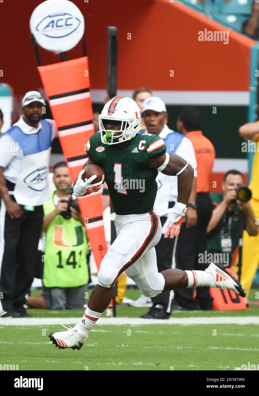 Miami running back Mark Walton (1) runs up the sidelines against Toledo ...
