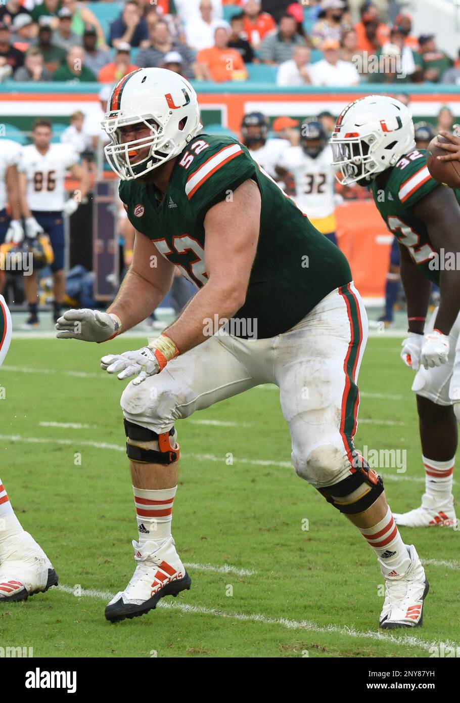 Miami tackle KC McDermott (52) blocks against Toledo during an NCAA ...