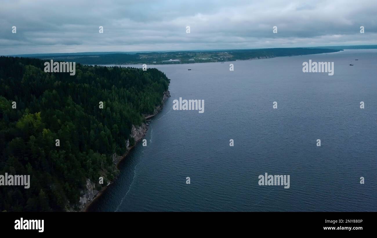 Aerial view of a forested cliff and the large blue lake. Clip. Amazing ...