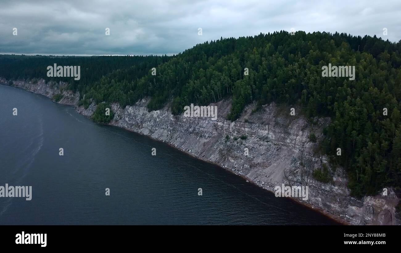 Aerial view of a forested cliff and the large blue lake. Clip. Amazing ...