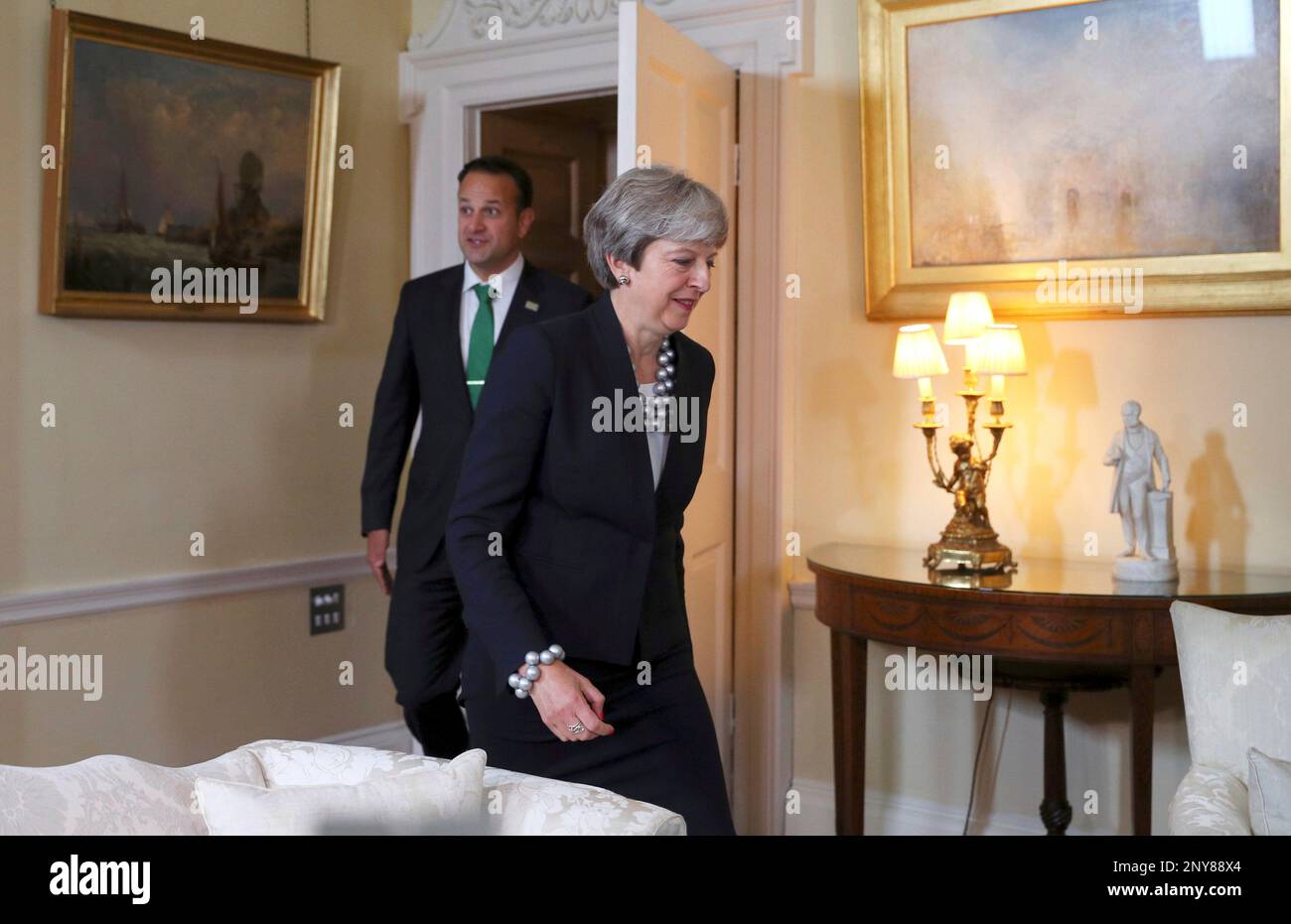 Britain's Prime Minister Theresa May, front, walks with Prime Minister ...