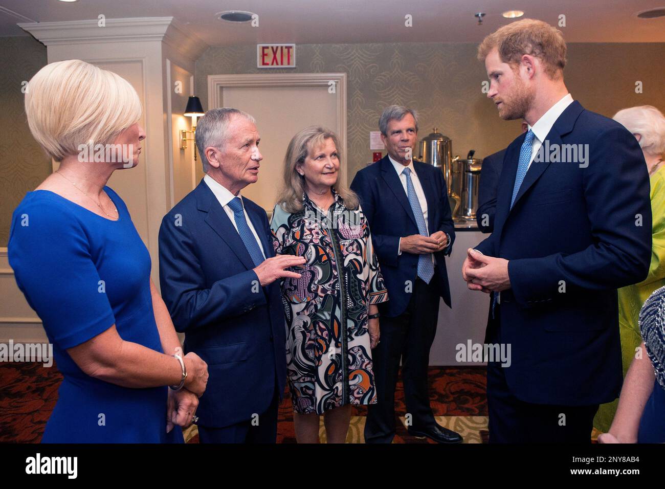 Prince Harry, right, chats with Phillip Crawley, second left, chief ...
