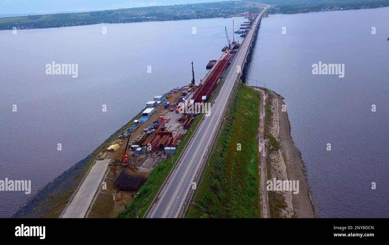 Aerial view of a long bridge crossing a wide river. Clip. Process of ...
