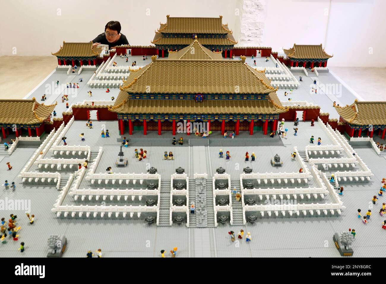 A woman takes a photo of the Forbidden City model made of Lego bricks ...