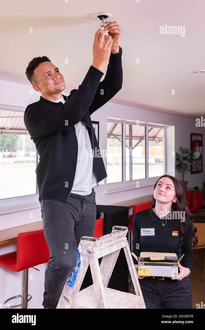 EDITORIAL USE ONLY Jermaine Jenas and Megan Roach installs an LED light ...