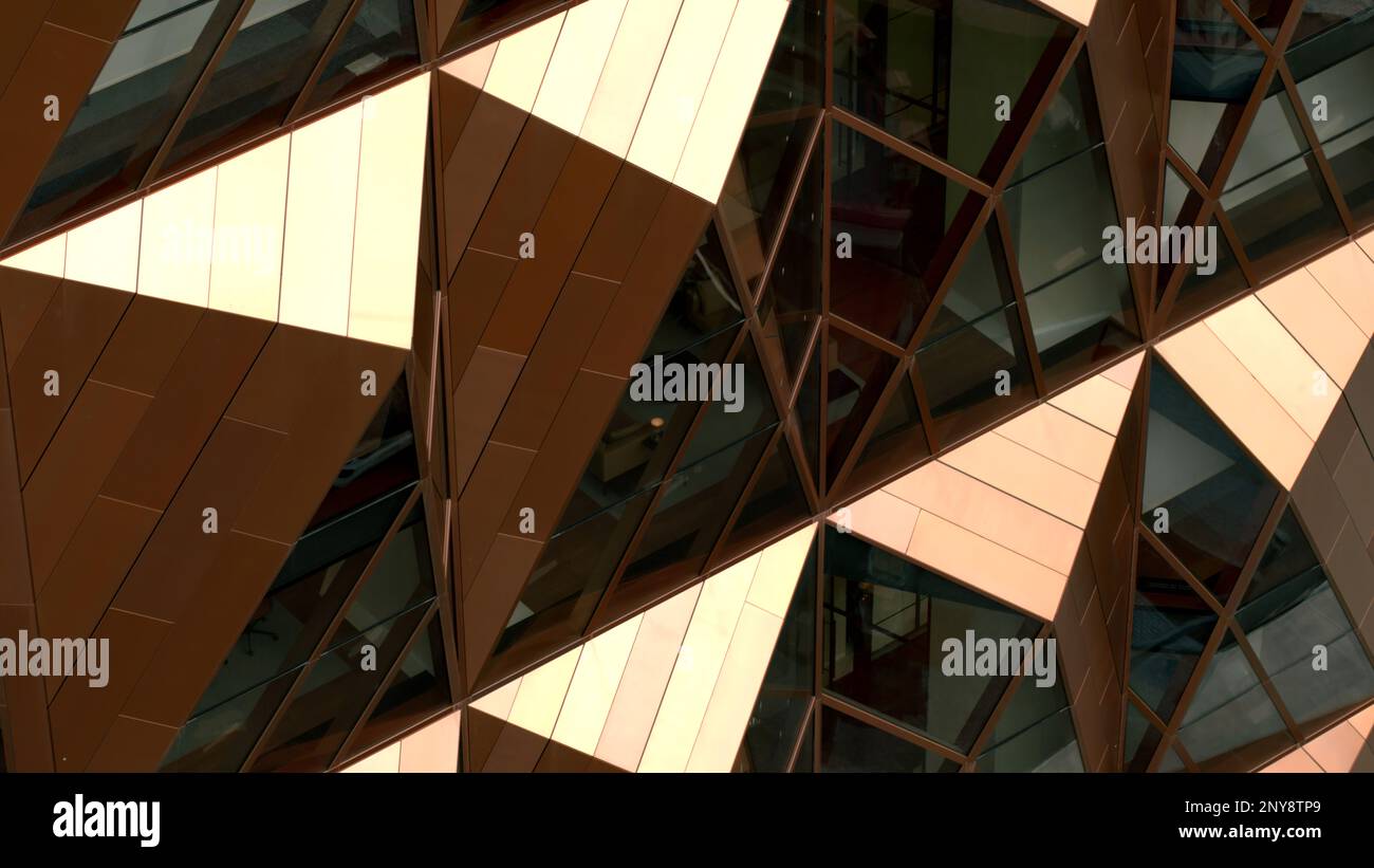 Aerial shot of the modern glass skyscraper exterior with sunshine and ...