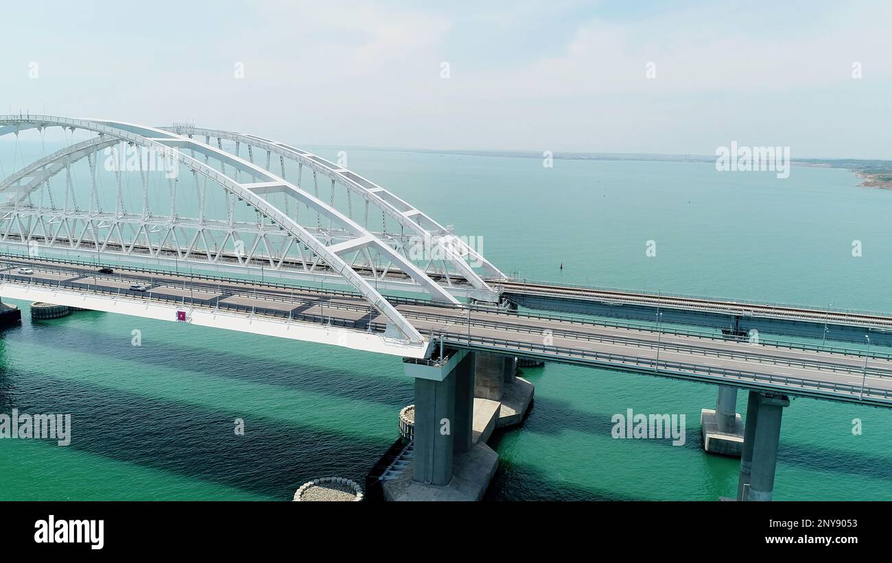 Aerial breathtaking view of the turquoise sea and a long white bridge ...